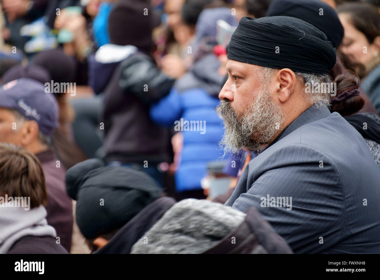 Older Sikh man closeup within a crowd celebrating Vaisakhi in London ...