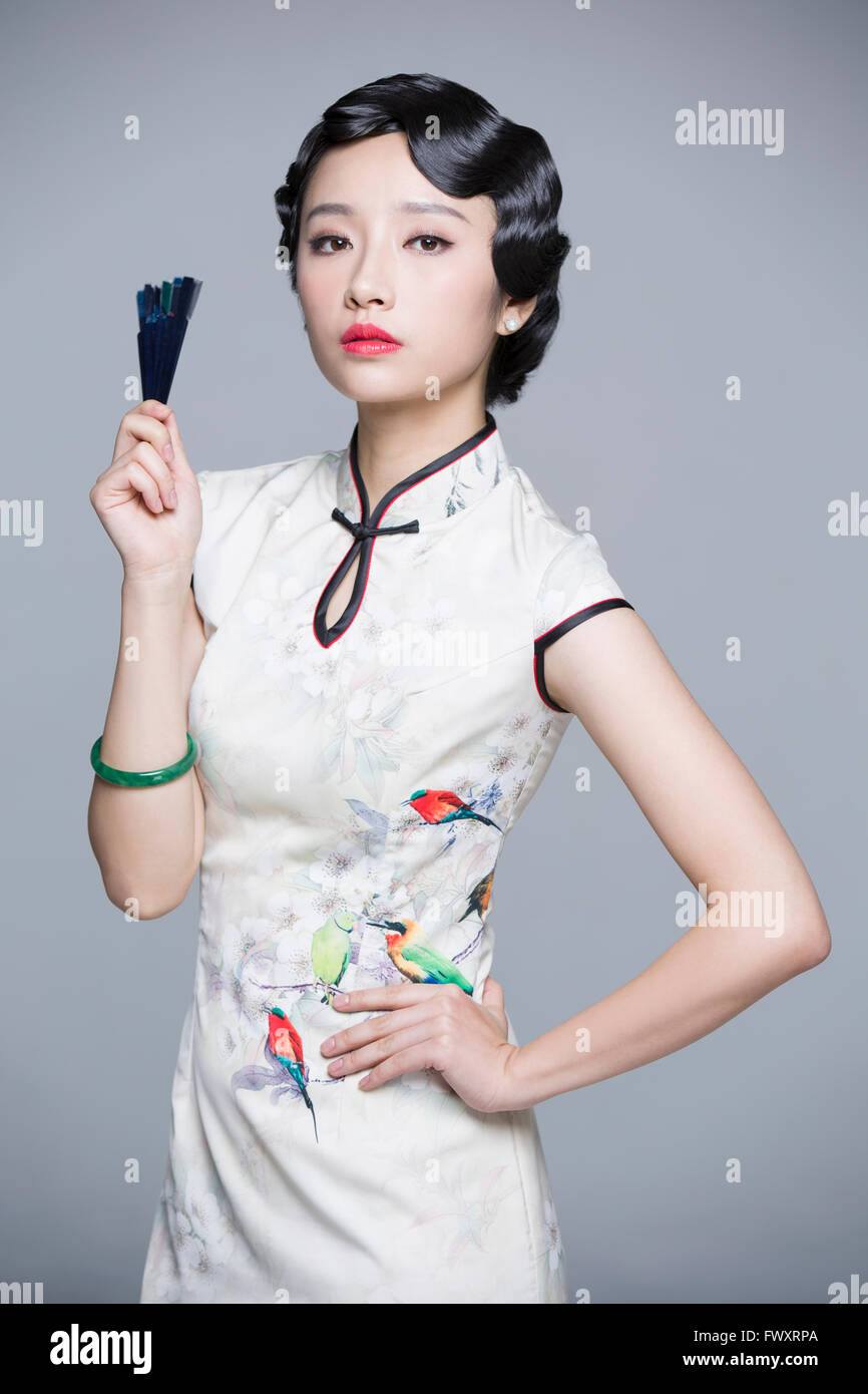 Young beautiful woman in traditional cheongsam with folding fan Stock ...