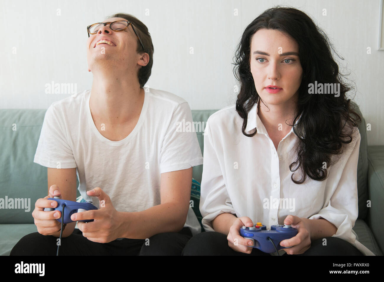 Sweden, Man and woman playing video game Stock Photo - Alamy