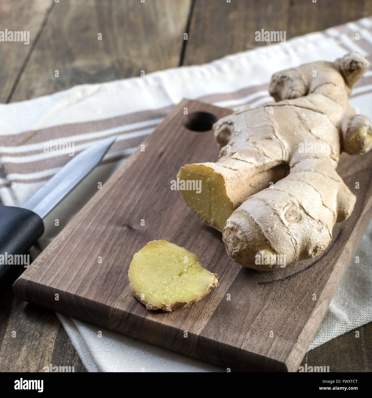 Fresh ginger root on a cutting board, close up Stock Photo - Alamy