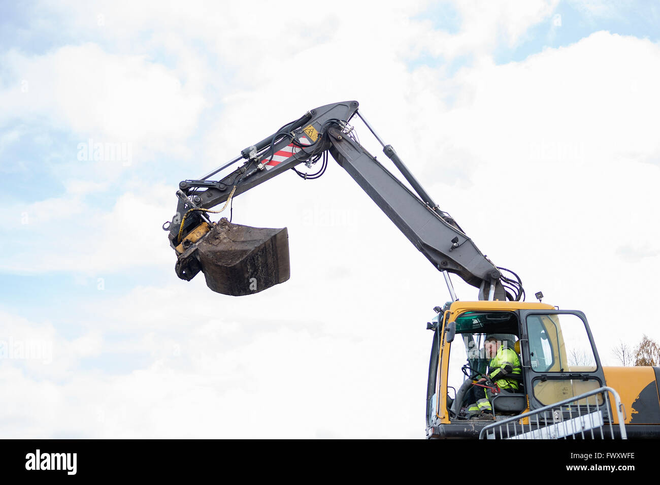 Sweden, Vastmanland, Man sitting inside earth mover Stock Photo - Alamy