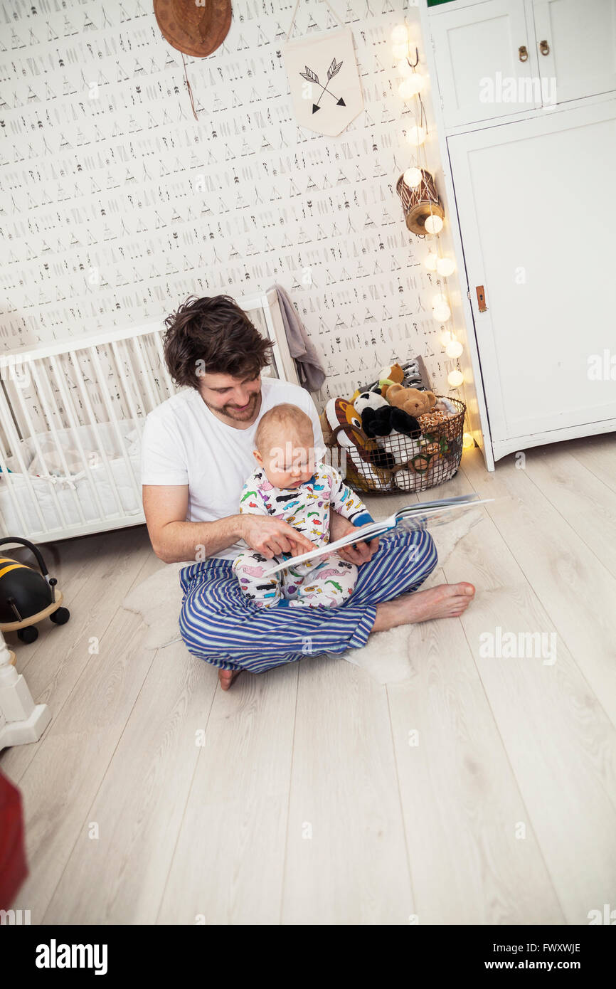 Sweden, Father reading book with son (12-17 months Stock Photo - Alamy