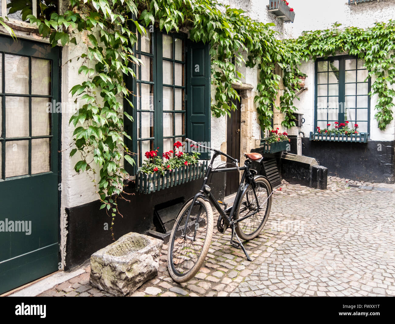 Small medieval alley called Vlaeykensgang in the city centre of Antwerp ...