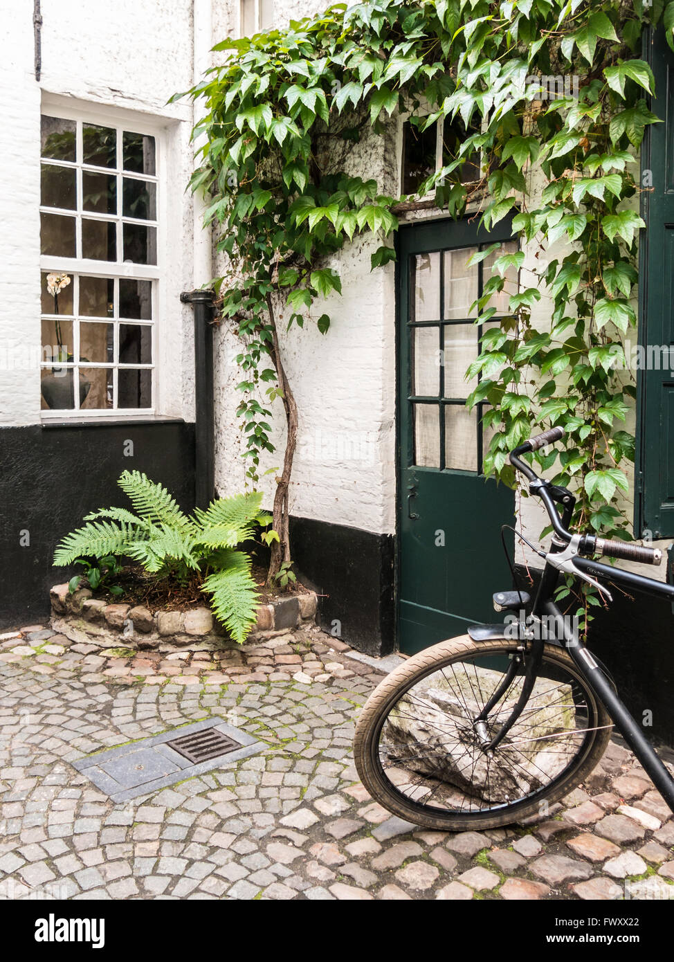 Small medieval alley called Vlaeykensgang in the city centre of Antwerp ...