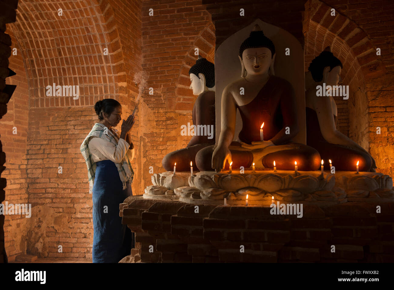 Myanmar lighting candles in a Buddhist temple Stock Photo - Alamy