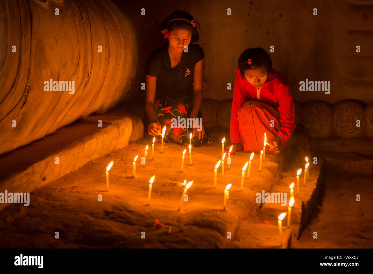 Myanmar lighting candles in a Buddhist temple Stock Photo - Alamy