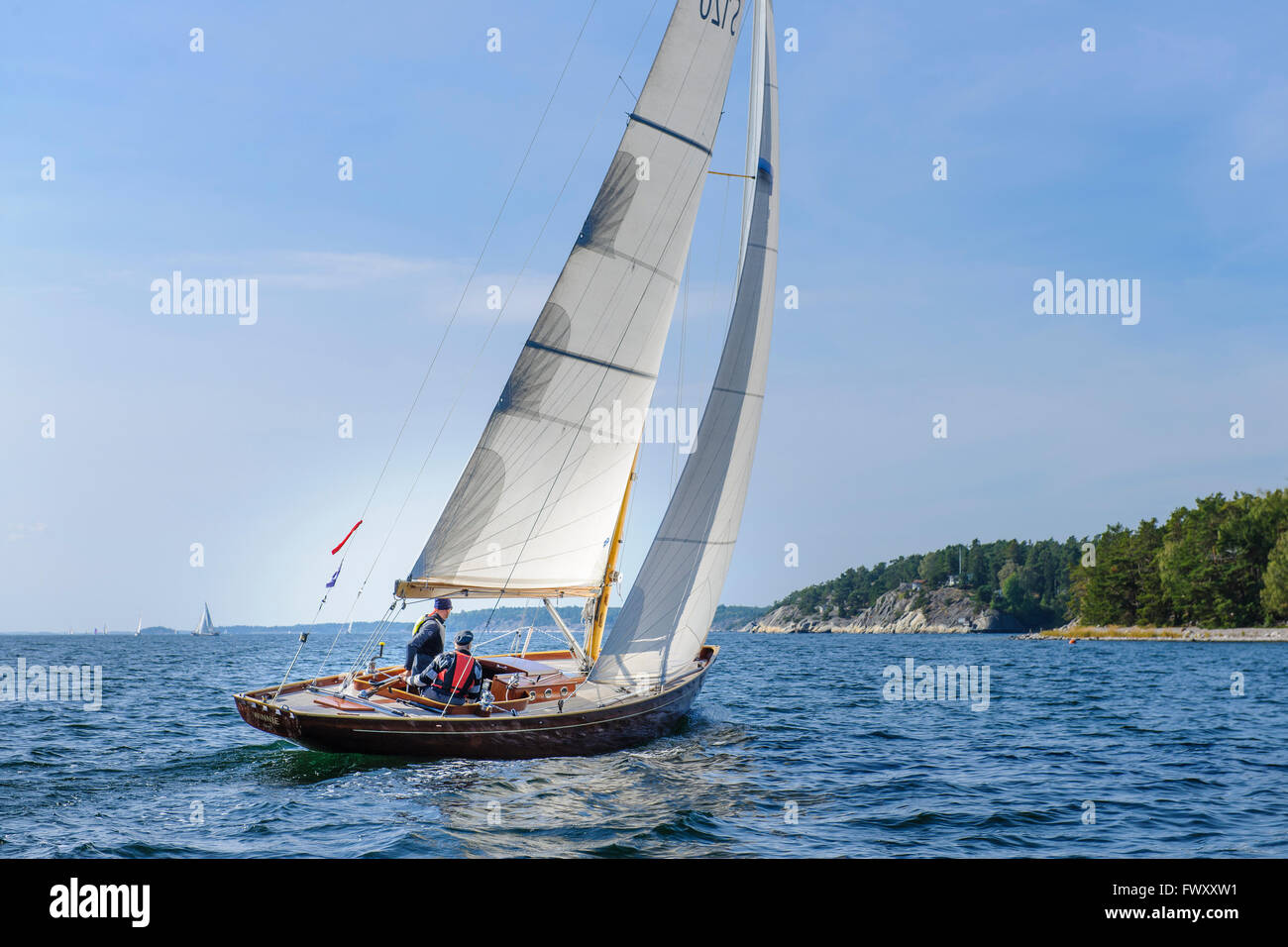 Sweden, Stockholm Archipelago, Uppland, Two men on sailboat Stock Photo ...