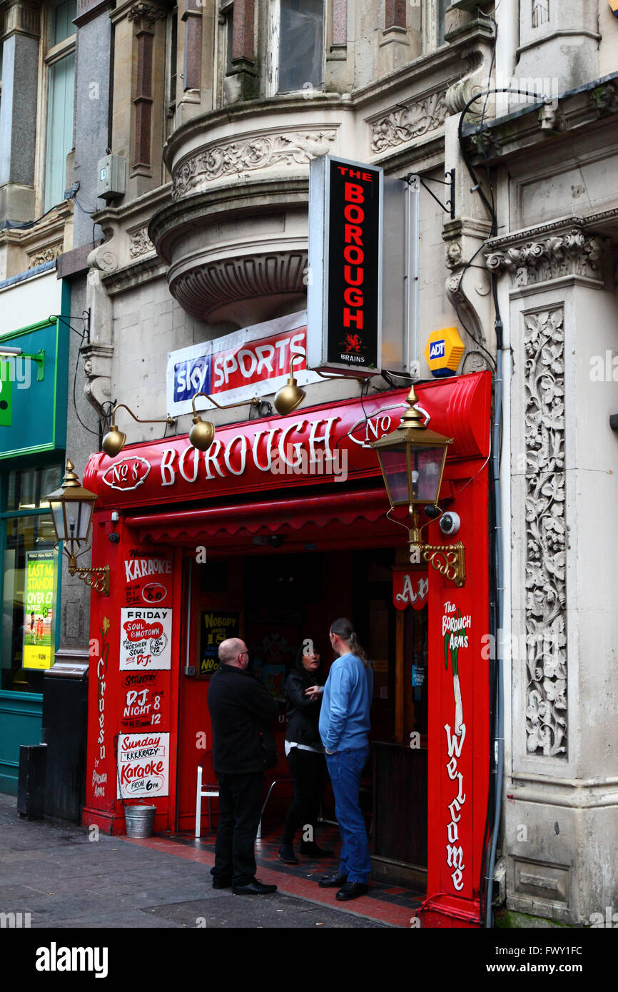 People chatting and smoking outside entrance to The Borough Arms pub at ...