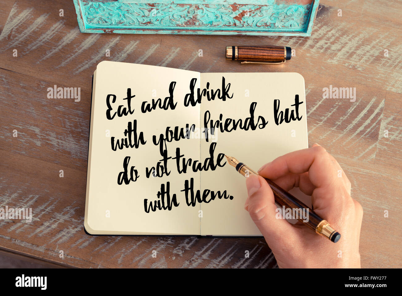 Retro effect and toned image of a woman hand writing on a notebook ...