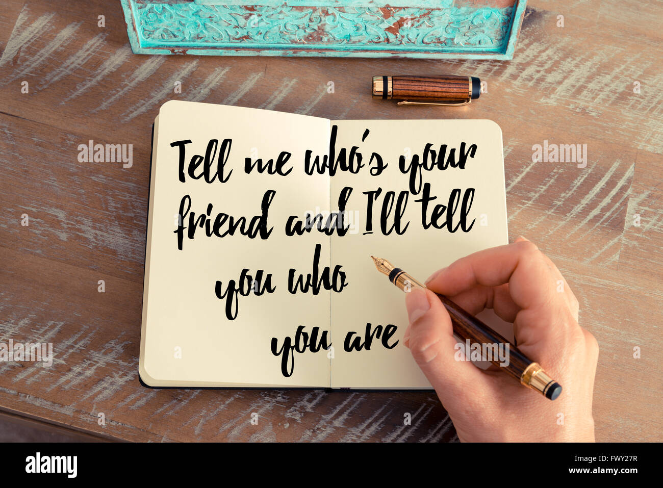 Retro effect and toned image of a woman hand writing on a notebook ...