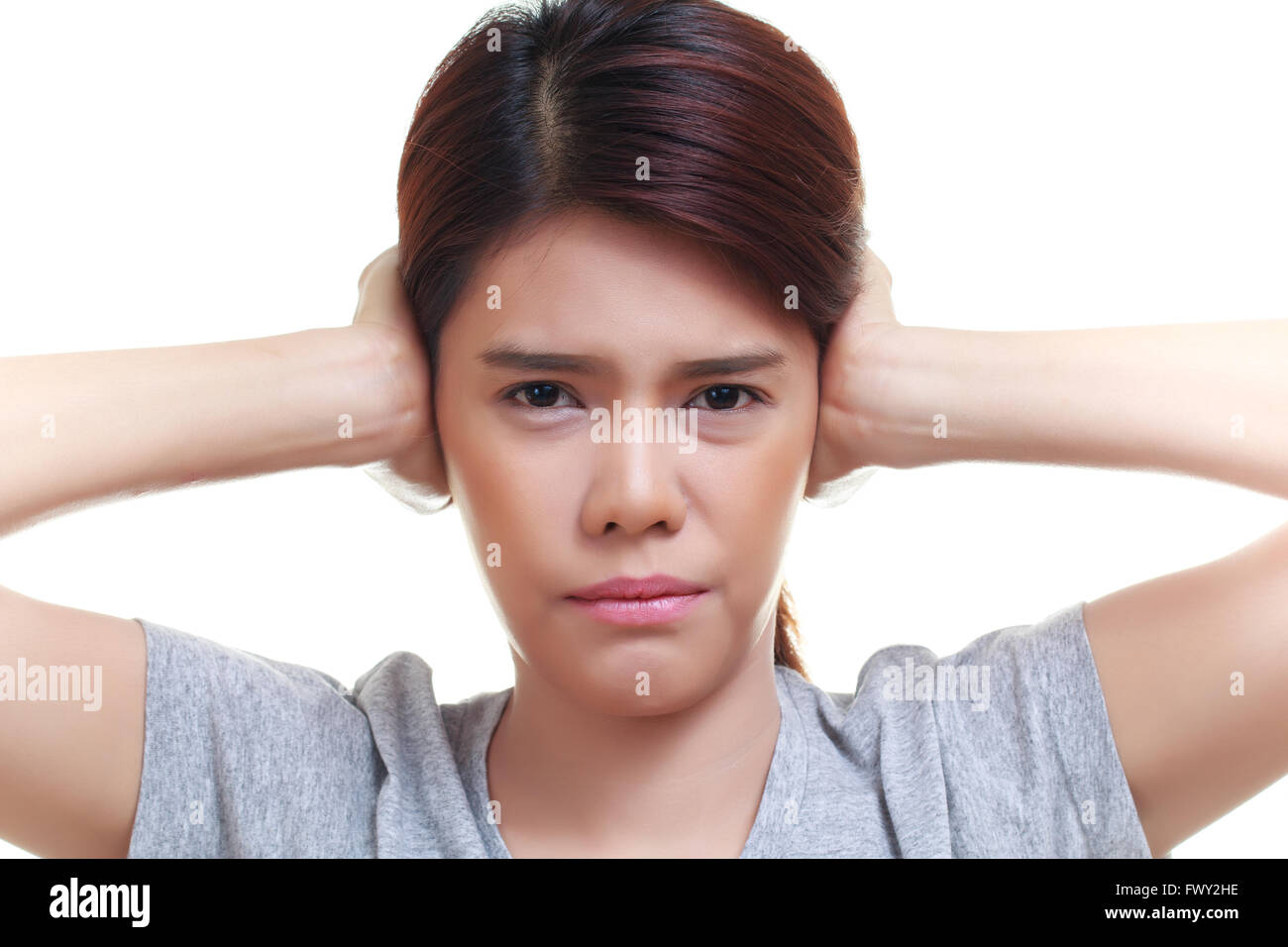 Beautiful young woman is touching her ear and closing her ears from ...