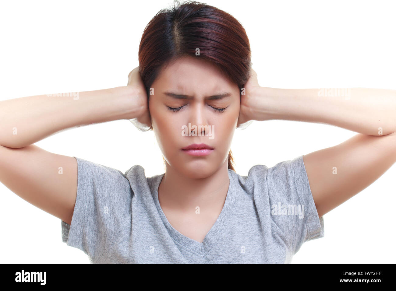 Beautiful young woman is touching her ear and closing her ears from ...