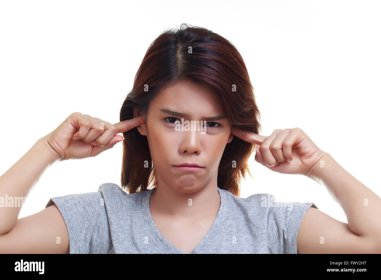 Beautiful young woman is touching her ear and closing her ears from ...
