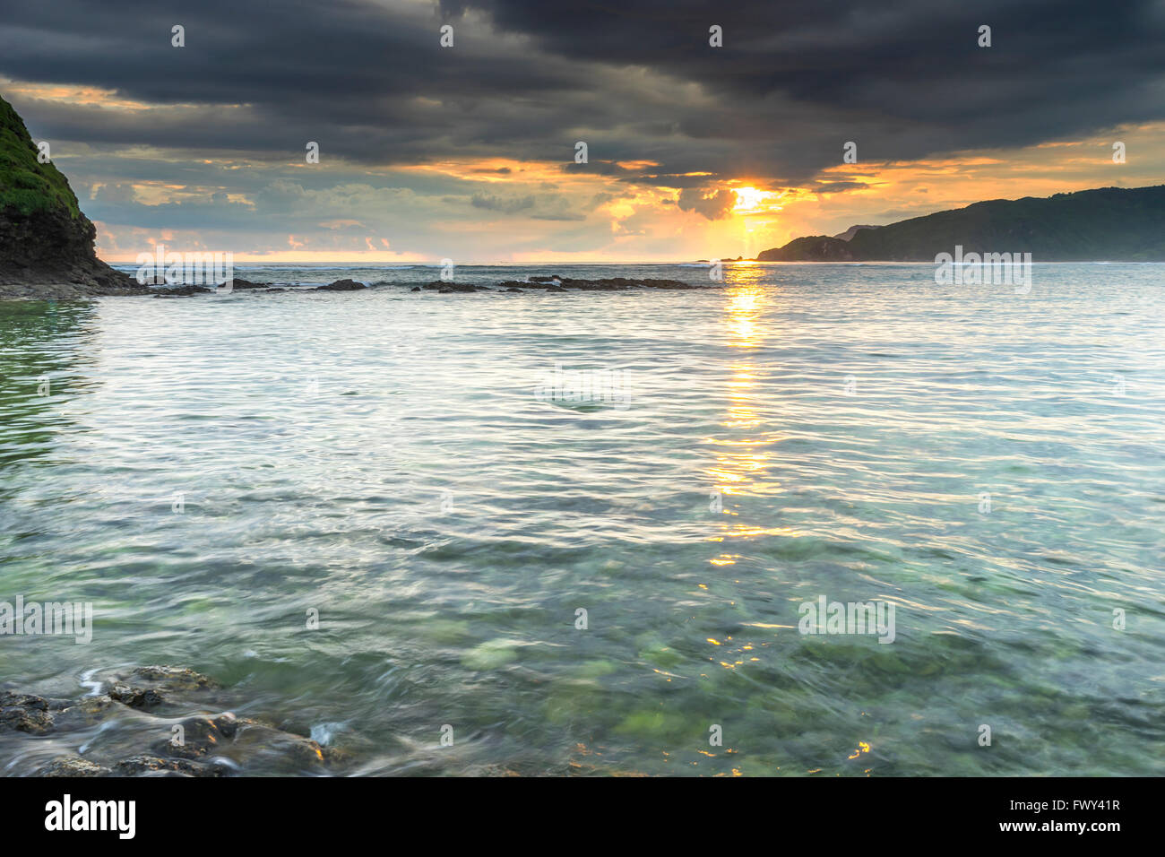 Natural green moss at beach rock with cloudy sunset background Stock ...