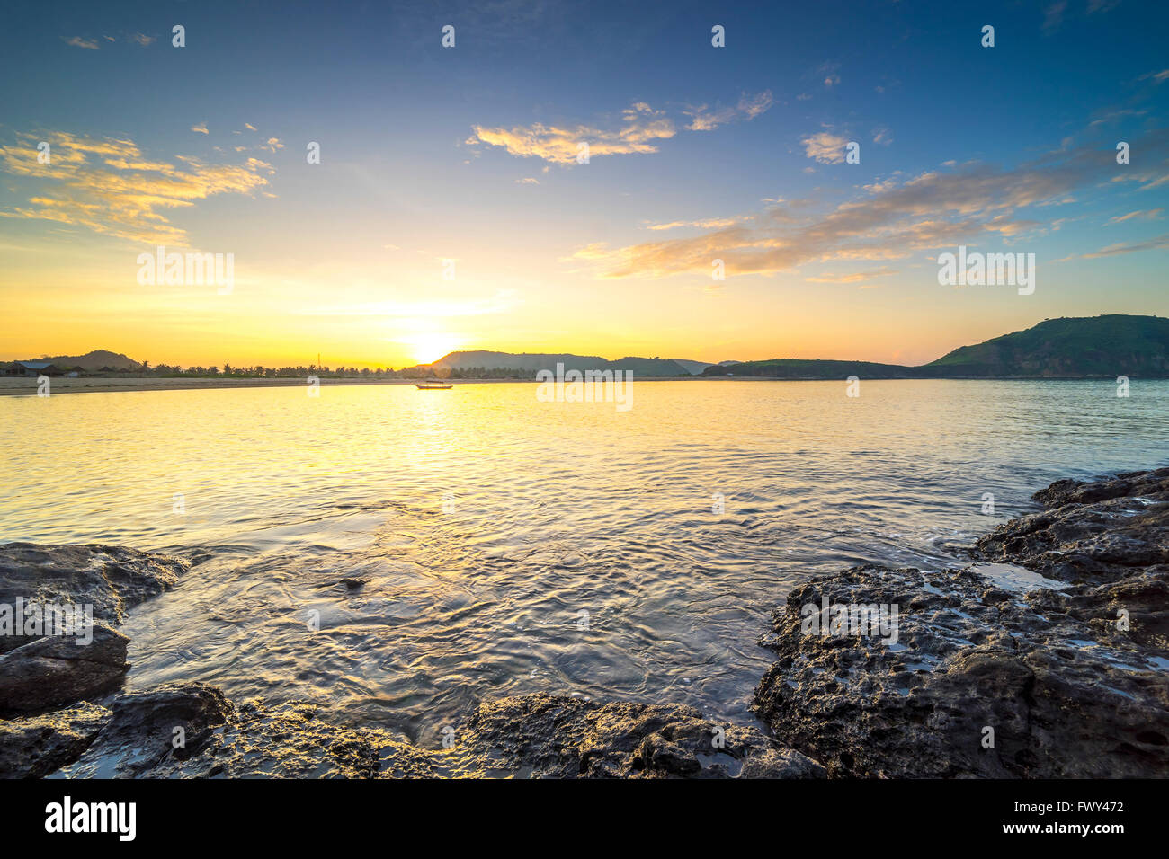 Beach rocks and water wave with sunrise background Stock Photo - Alamy