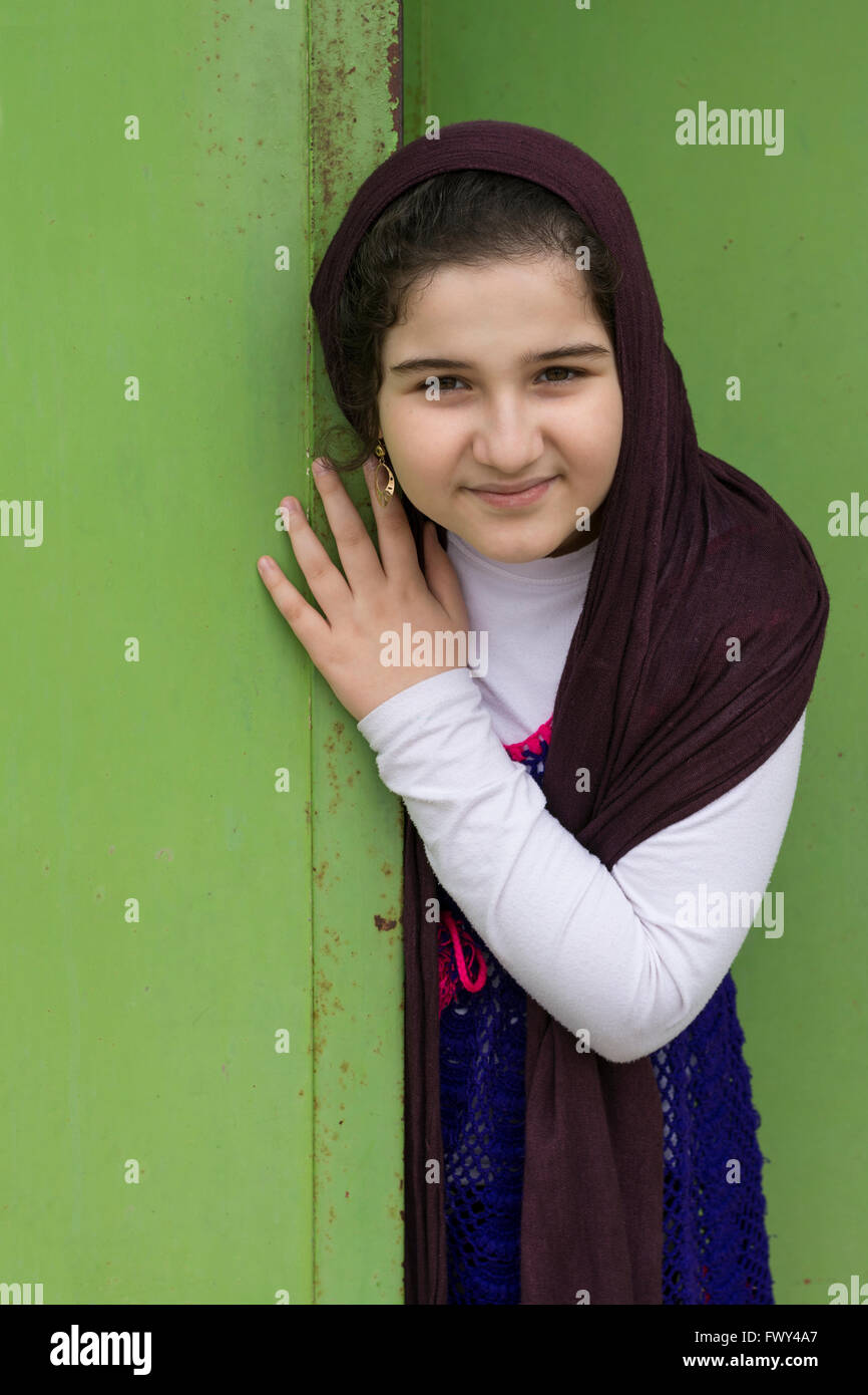A Close up Portrait of a Beautiful Muslim Girl In Front of a Green ...