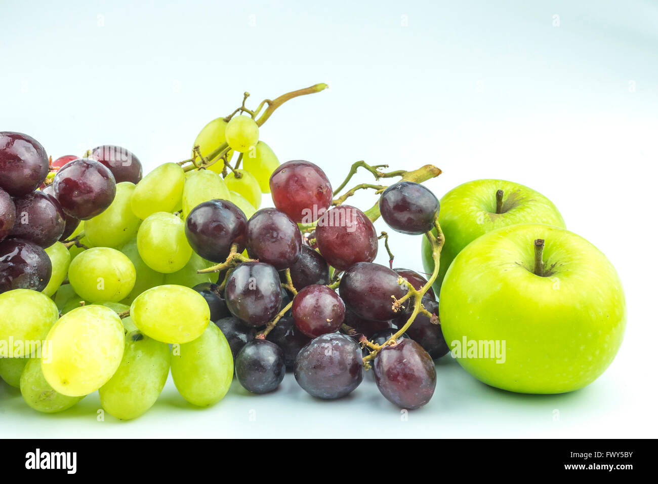 Grape and apple with white background Stock Photo - Alamy