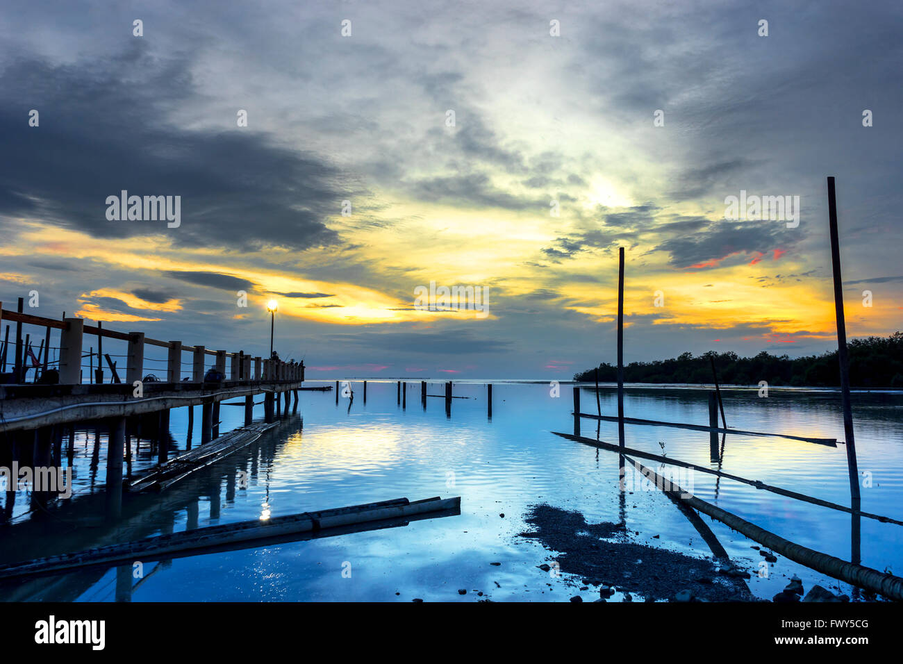 Jetty with sunset background Stock Photo - Alamy
