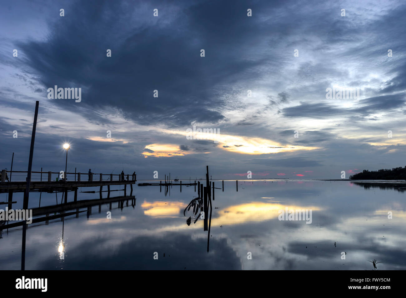 Jetty with sunset background Stock Photo - Alamy