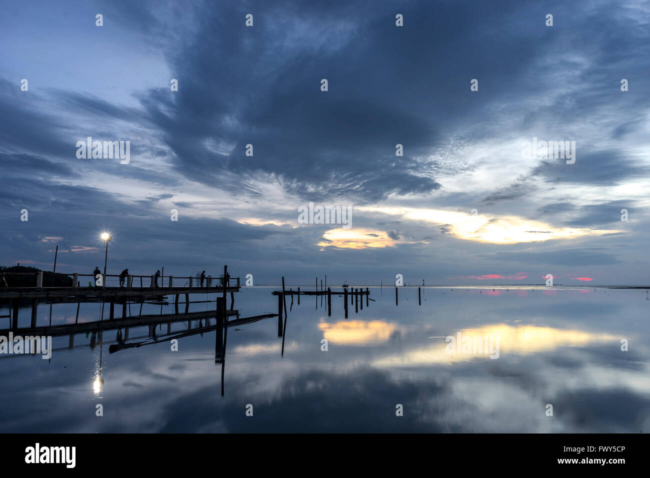 Jetty with sunset background Stock Photo - Alamy