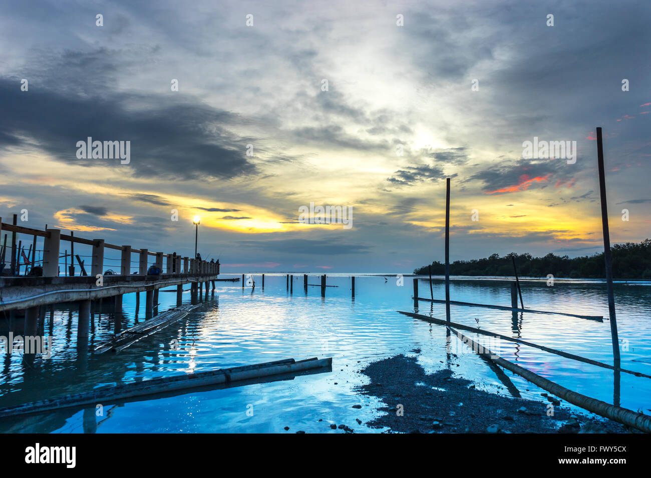 Jetty silhouette with sunset background Stock Photo - Alamy