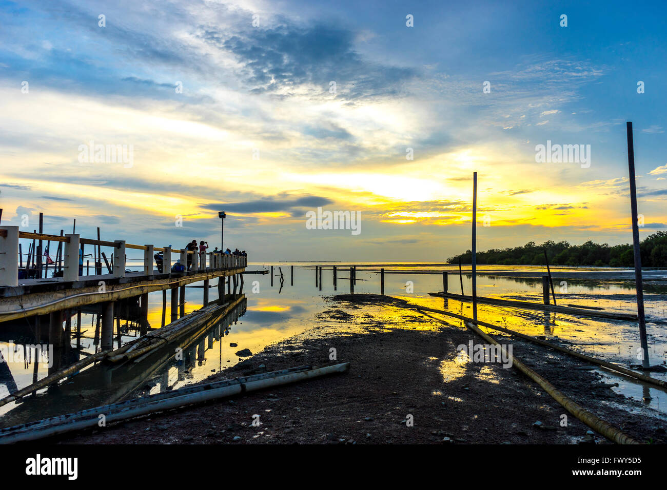 Jetty silhouette with sunset background Stock Photo - Alamy