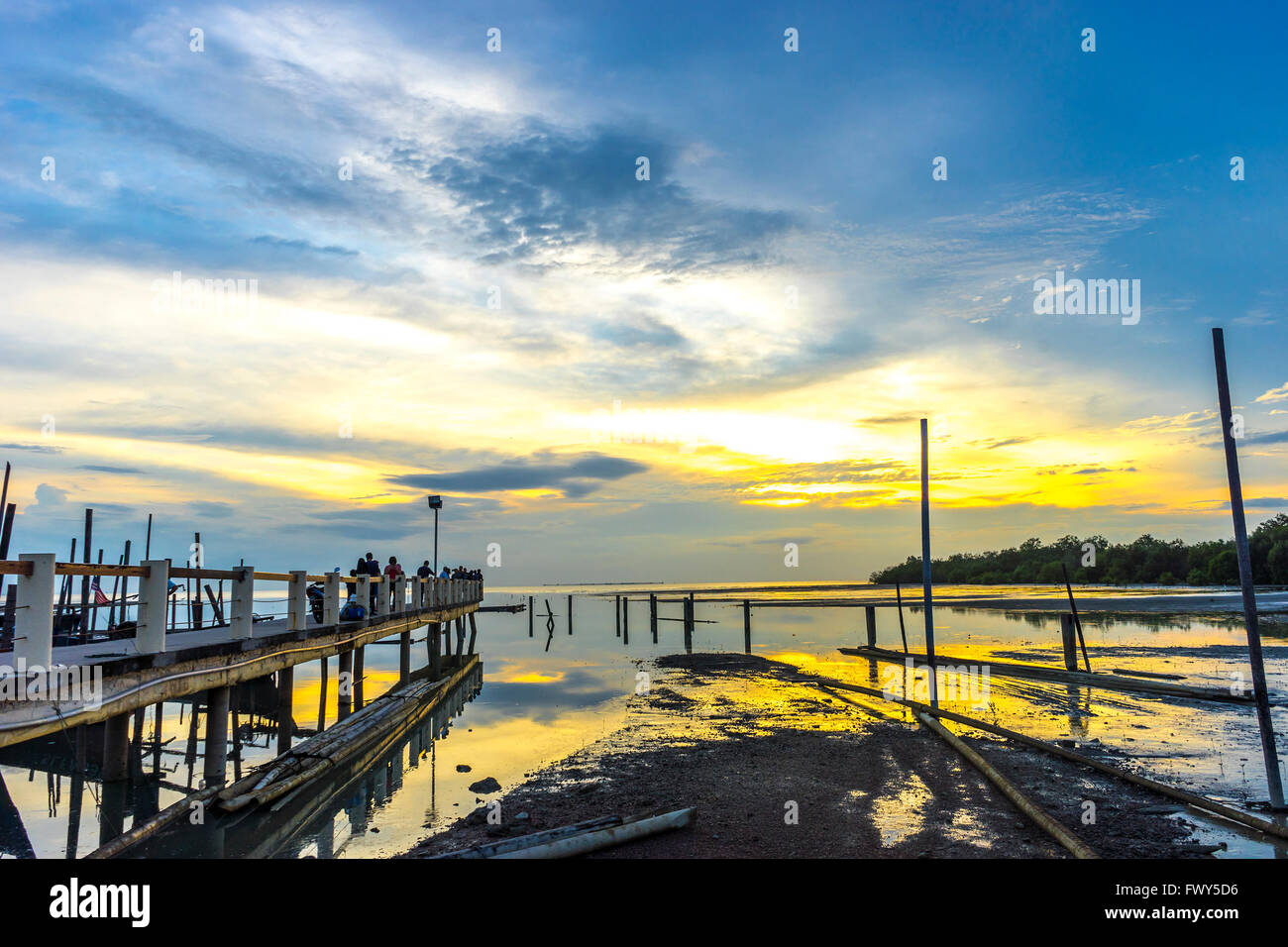 Jetty silhouette with sunset background Stock Photo - Alamy