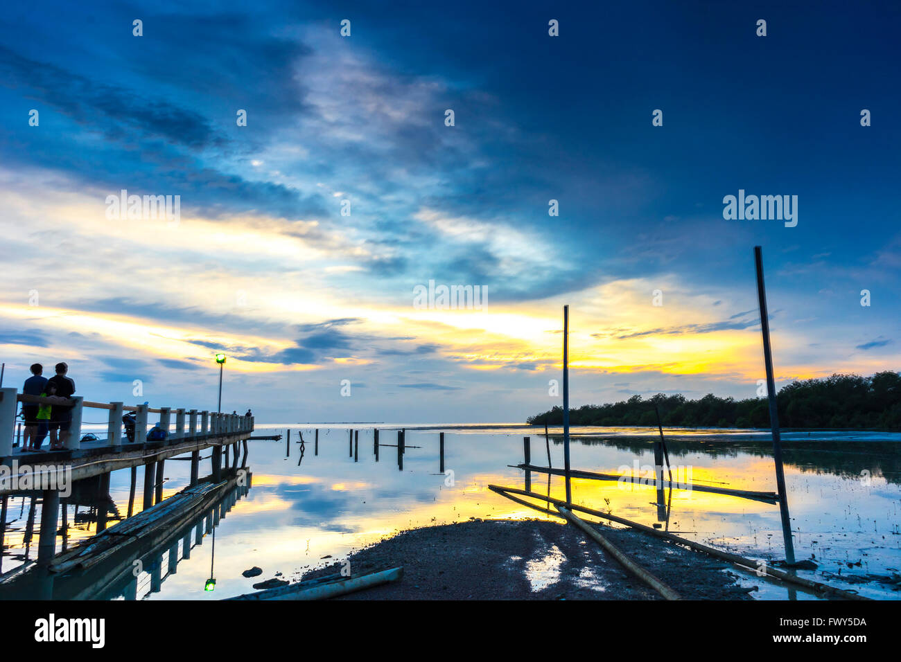 Jetty silhouette with sunset background Stock Photo - Alamy