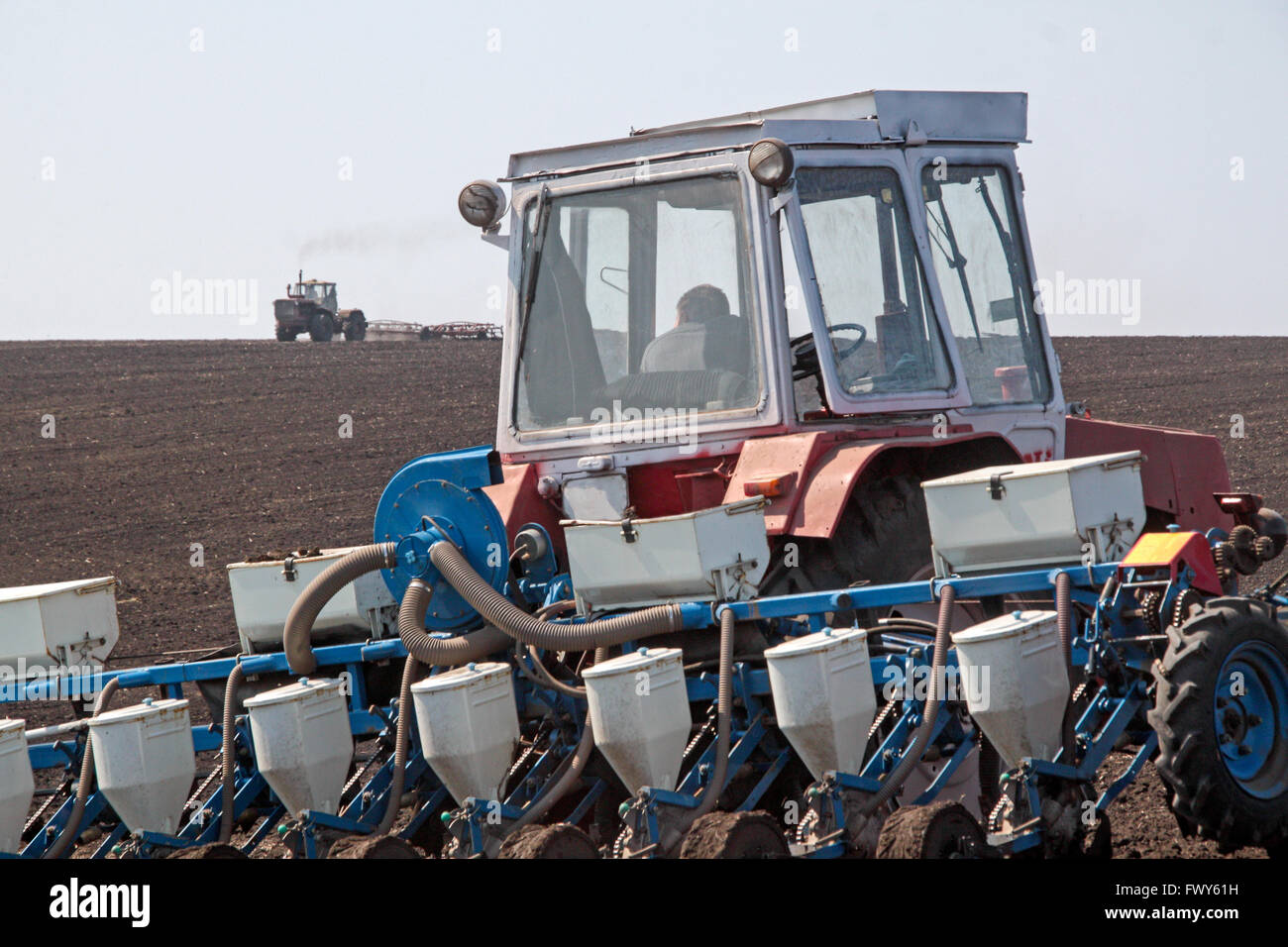 Tractor with sower on the field in bright sunny spring morning Stock ...