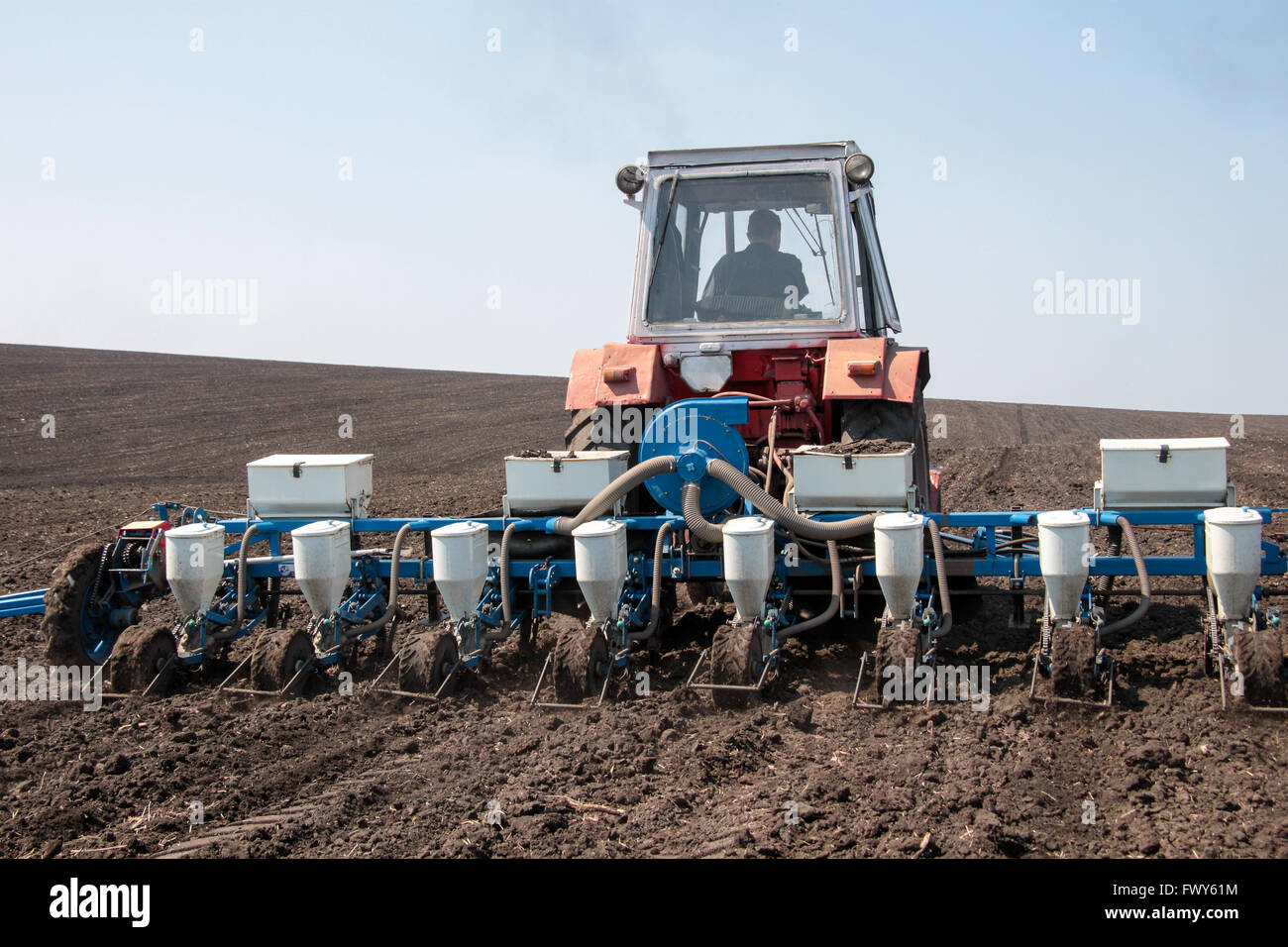 Tractor with sower on the field in bright sunny spring morning Stock ...