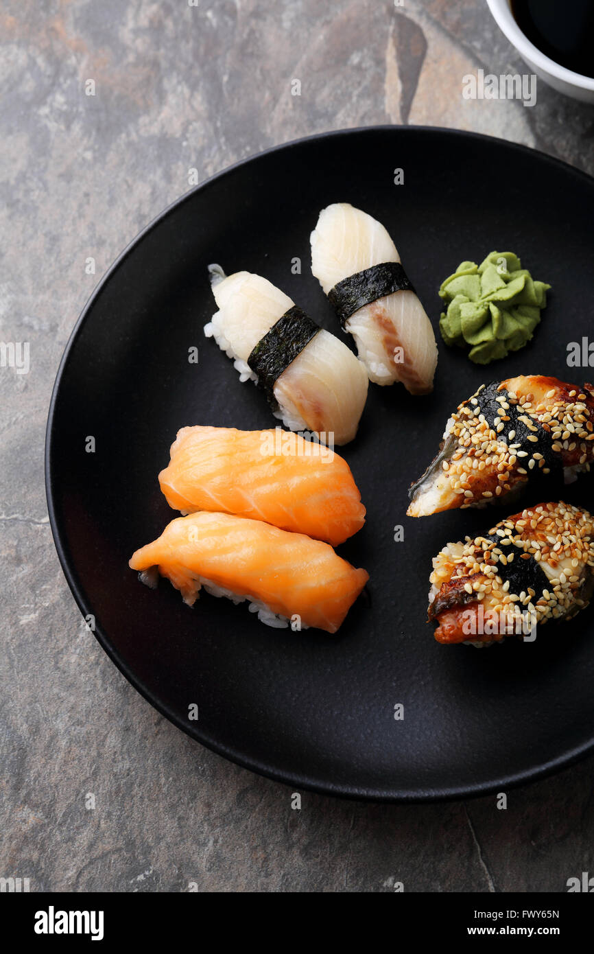 traditional asian food on black plate Stock Photo - Alamy