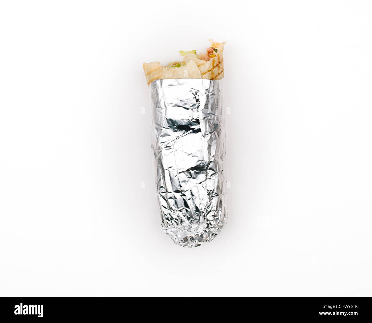 Durum kebab in foil paper with a bite Stock Photo - Alamy