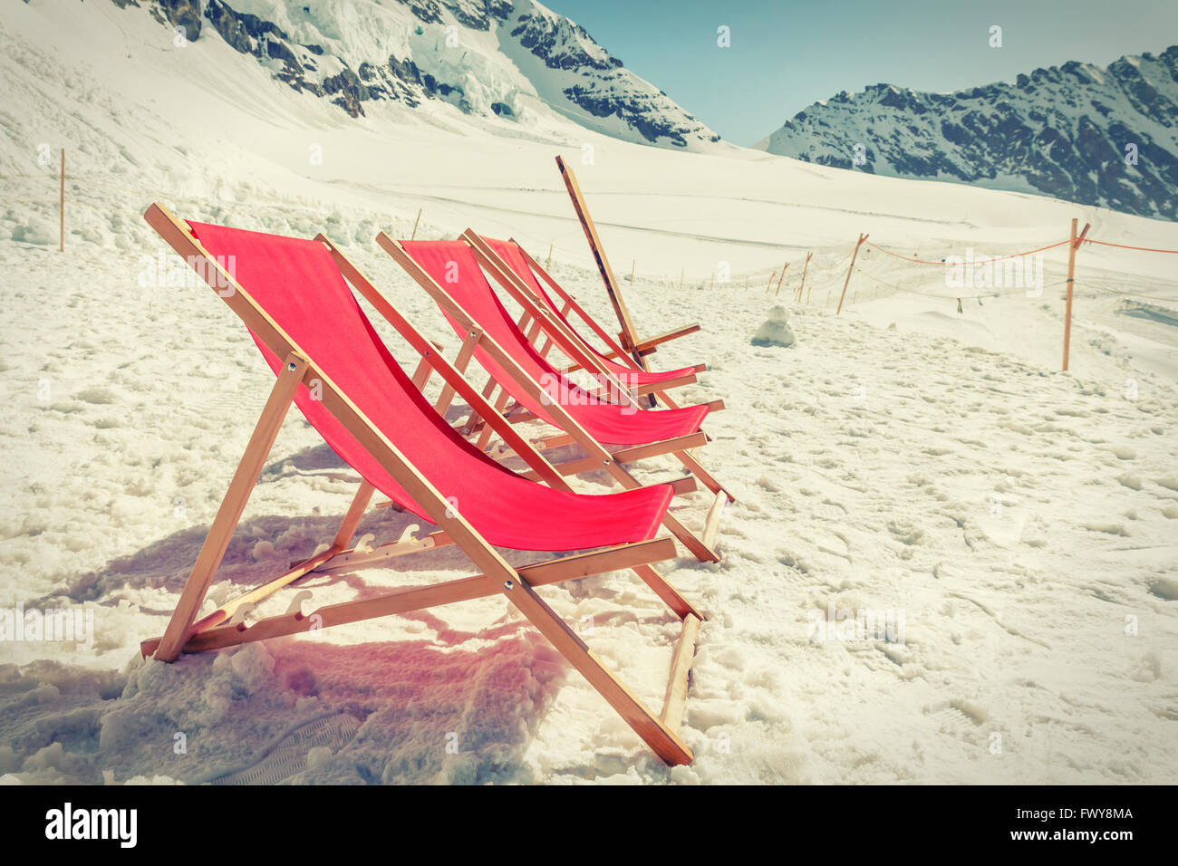 View of Empty red beds on the snow, relaxing concept, with vintage ...