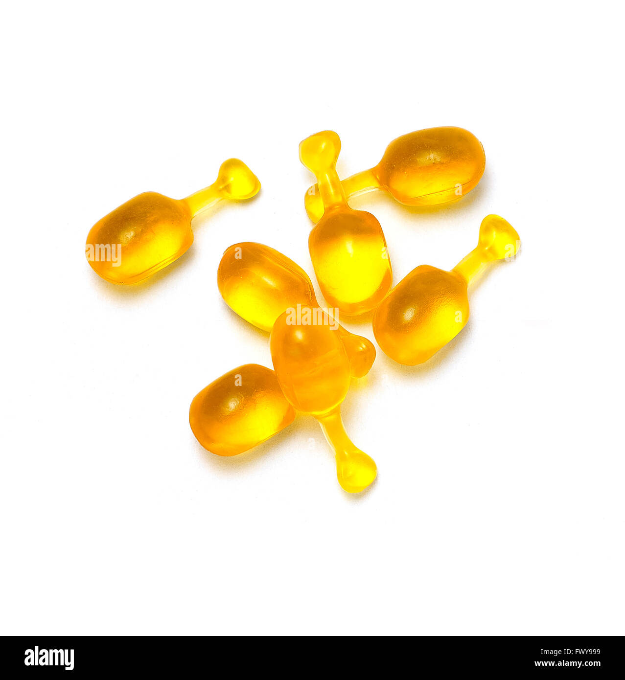 yellow serum capsules white background Stock Photo - Alamy