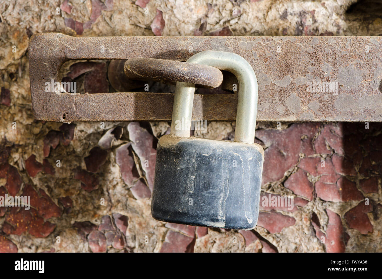 Old rusty padlock on damaged wooden doors surface Stock Photo - Alamy