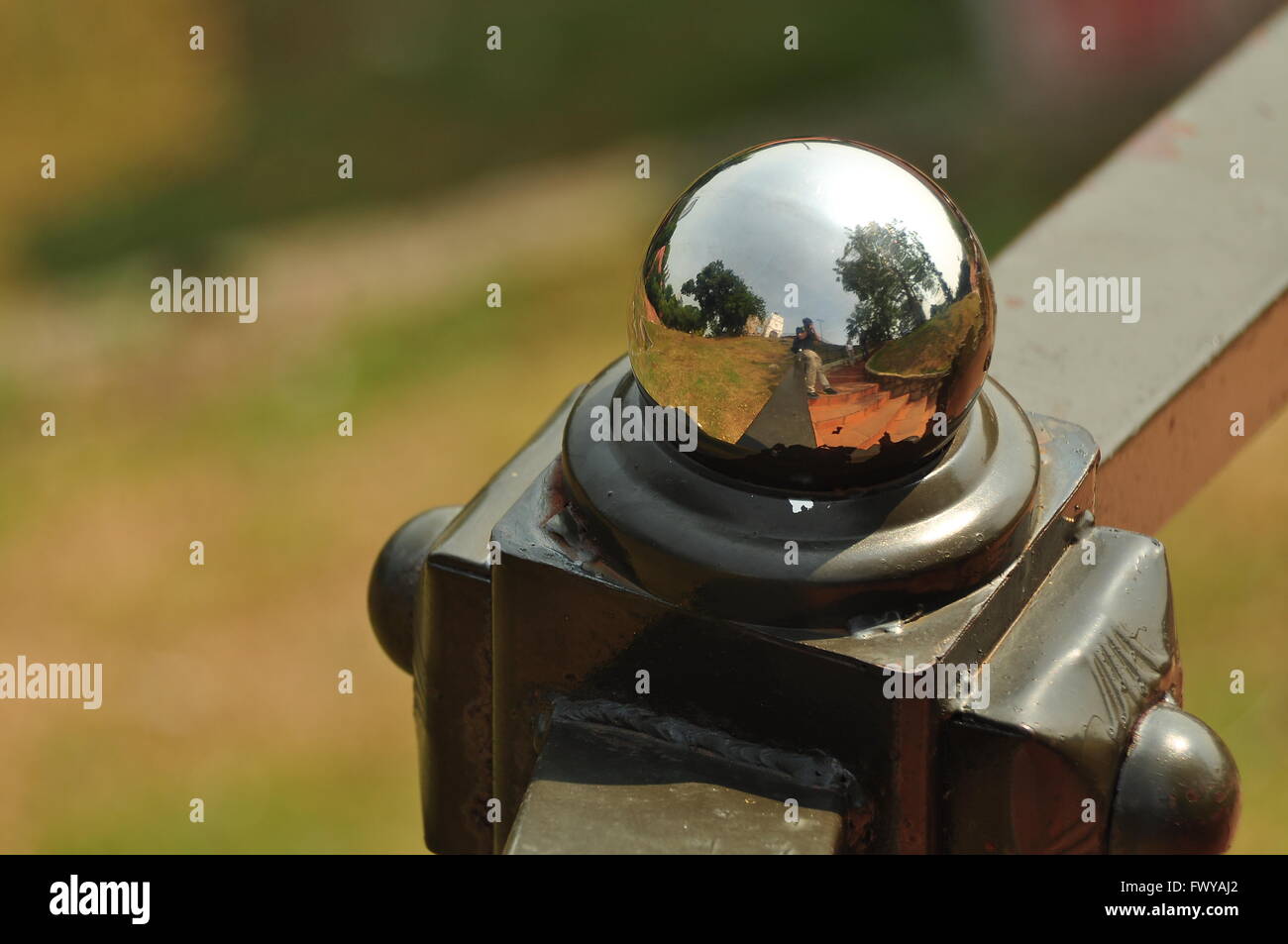 Reflection of the photographer on the metal sphere Stock Photo - Alamy