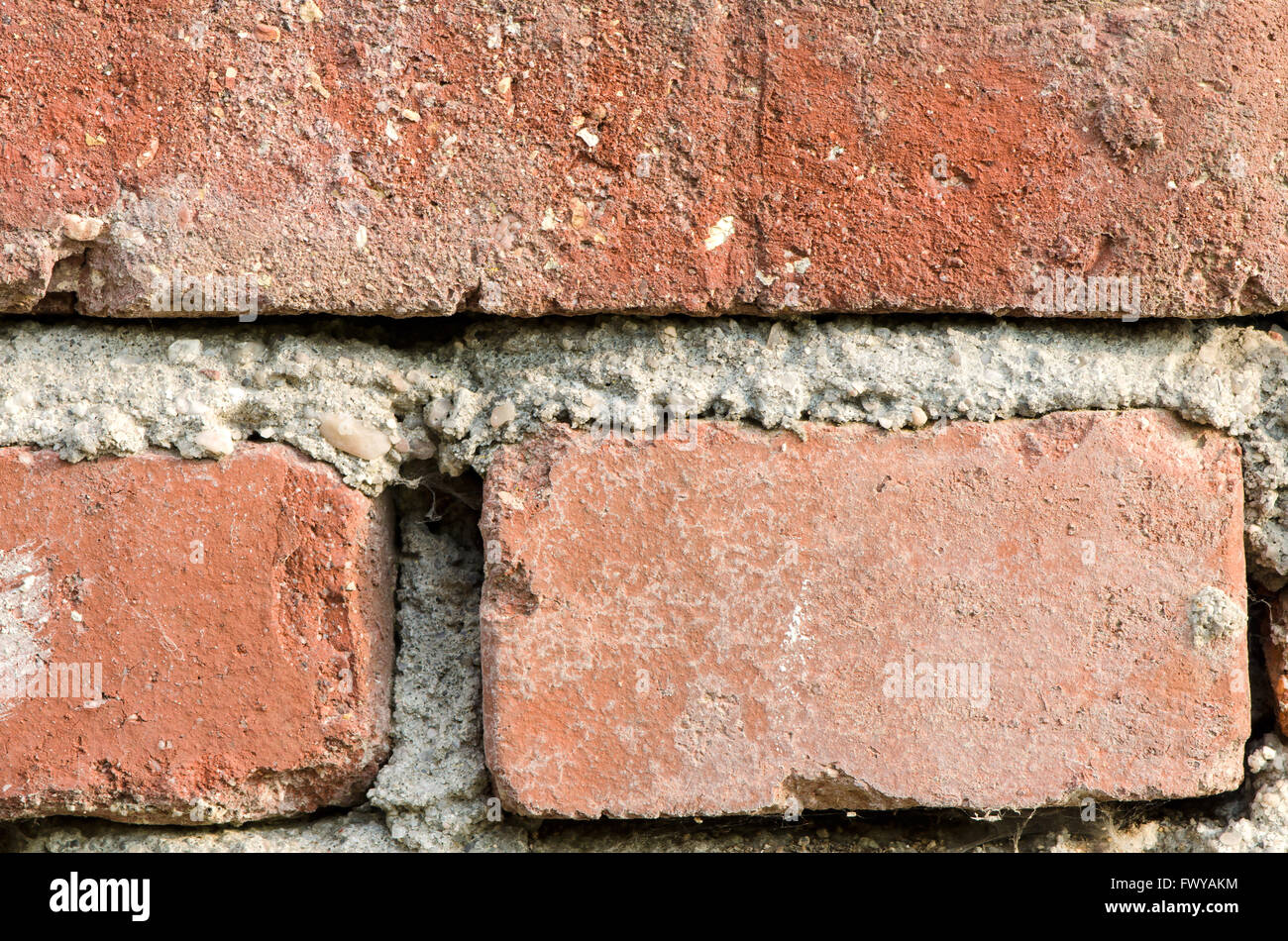 Detail of three bricks and cement wall background Stock Photo - Alamy