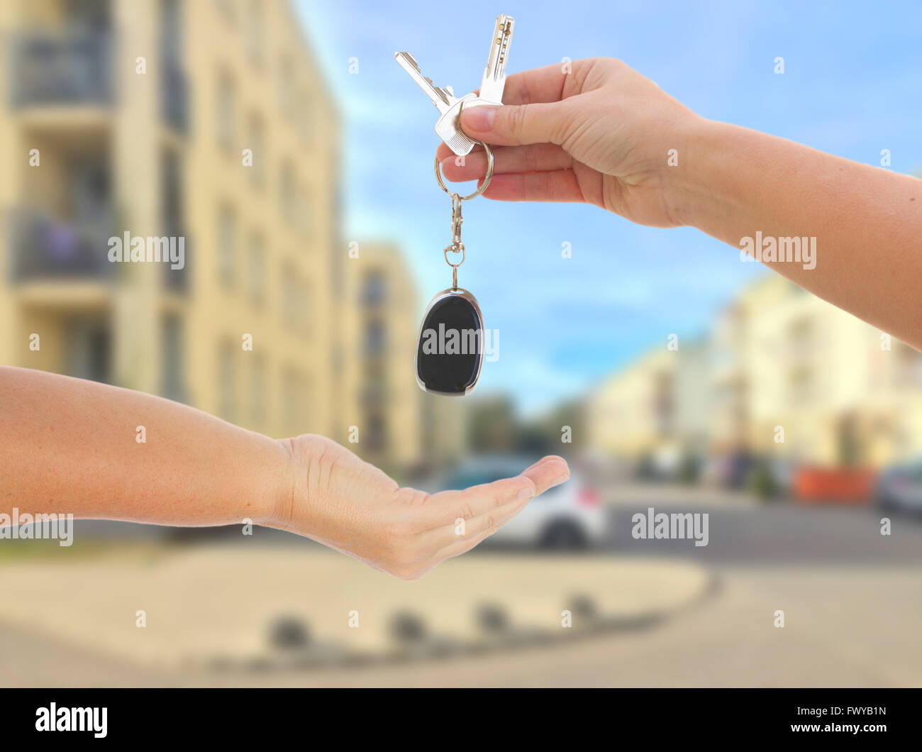 Two hands and a key Stock Photo - Alamy