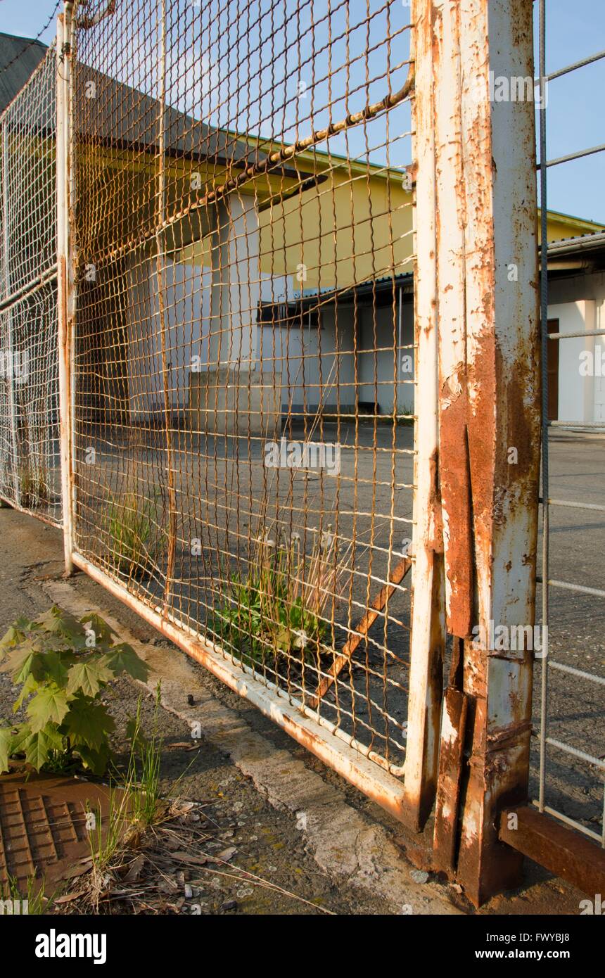 Rusty white gate to old stock building Stock Photo - Alamy