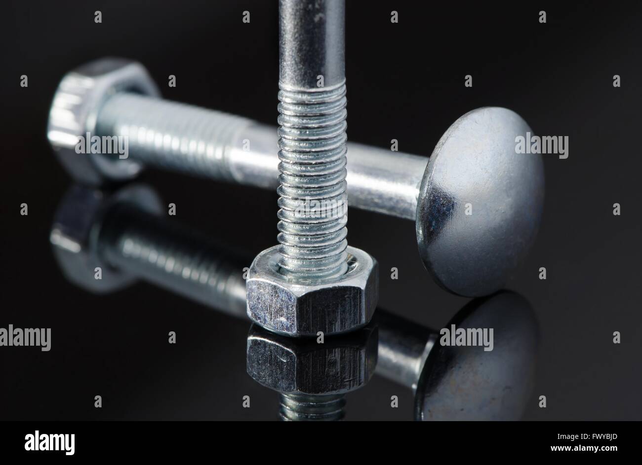 Two metal screws with nice reflection on black background Stock Photo ...