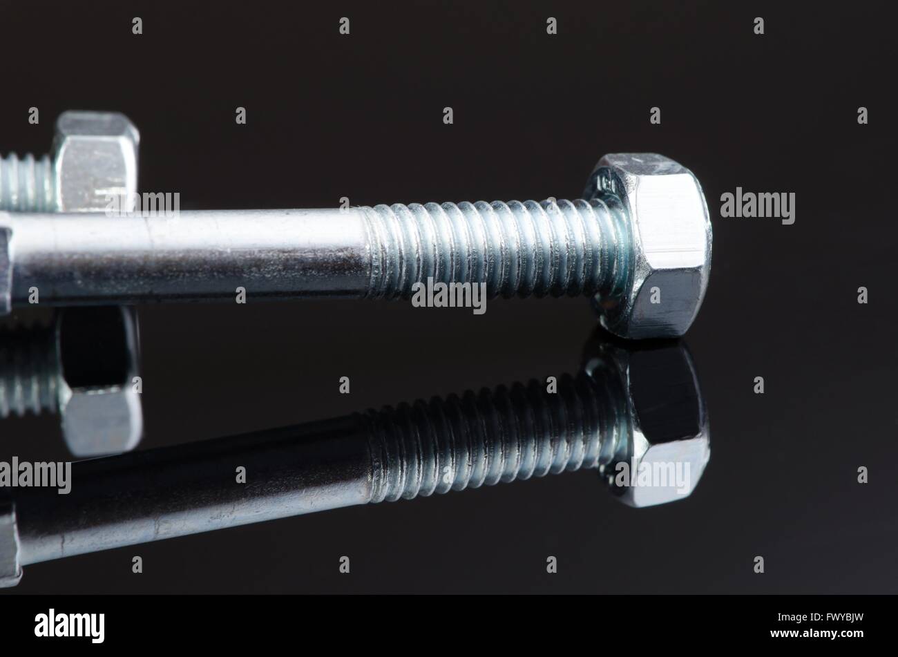 Two metal screws with nice reflection on black background Stock Photo ...