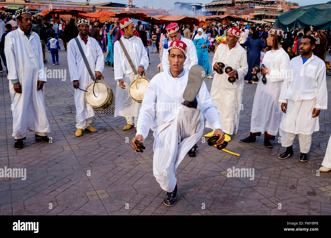 Men playing drums and performing a traditional dance in the Jemaa el ...