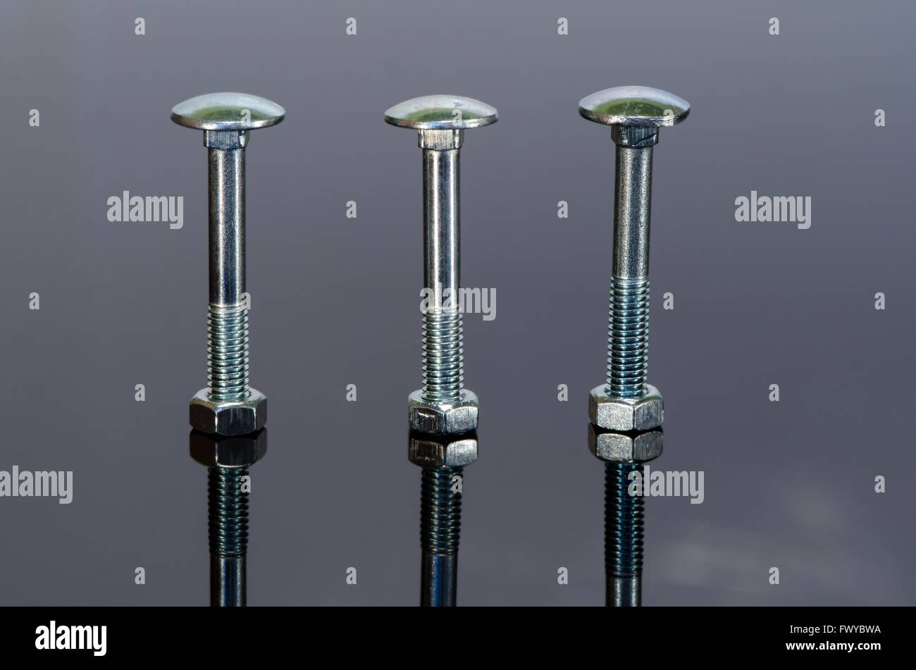 Three metal screw with nice reflection on black background Stock Photo ...