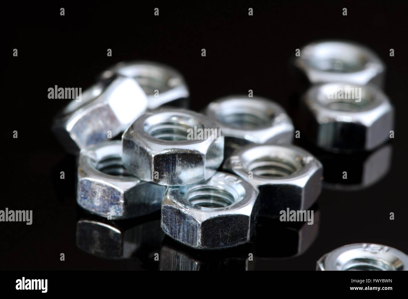 Metal female screws with reflection on black background Stock Photo - Alamy