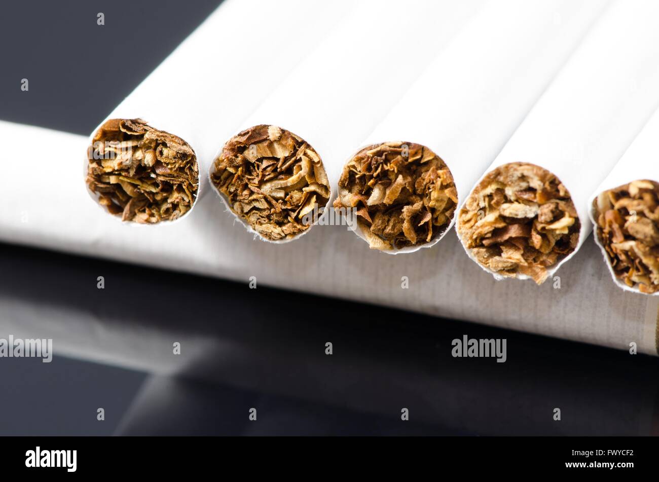 Lot of white cigarets in paper box isolated on black background Stock ...