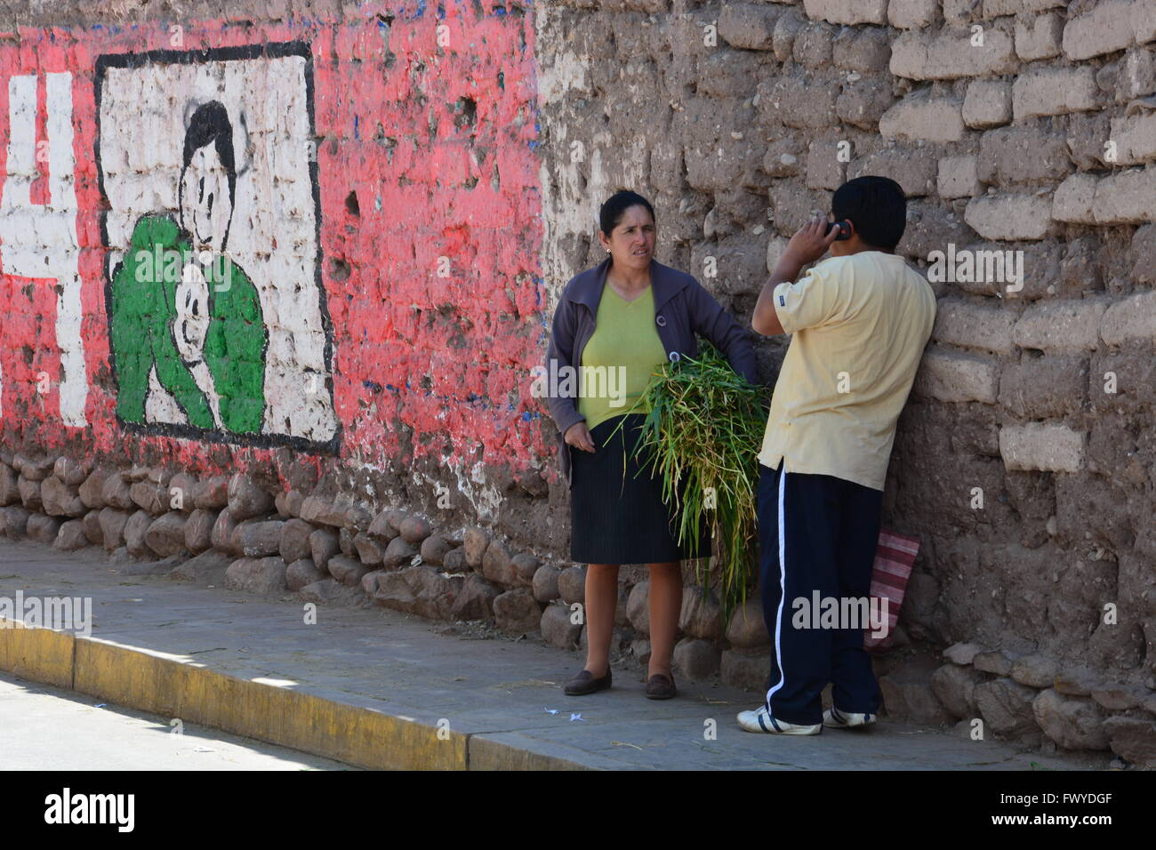 A man and woman talk on the street in Urubamba Peru Stock Photo - Alamy