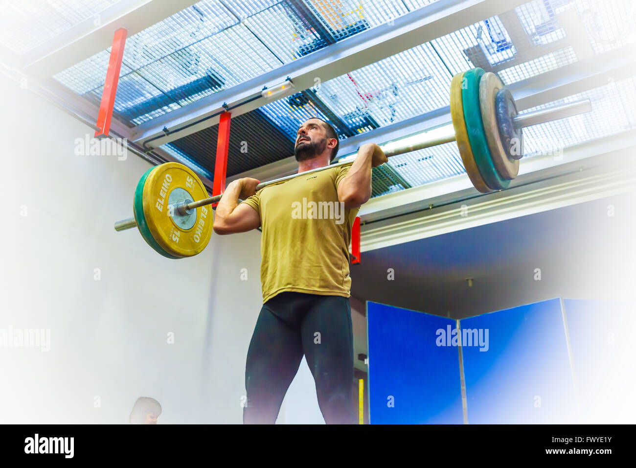 Middle-aged male bodybuilder lifting weight in a gym Stock Photo - Alamy