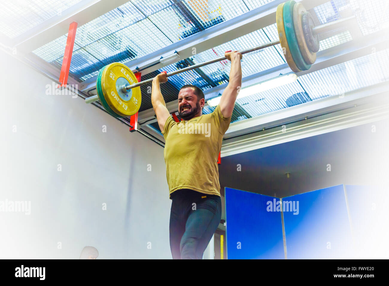 Middle-aged male bodybuilder lifting weight in a gym Stock Photo - Alamy
