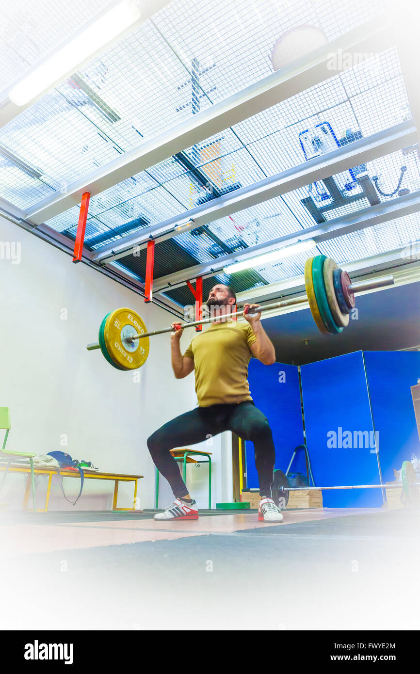 Middle-aged male bodybuilder lifting weight in a gym Stock Photo - Alamy