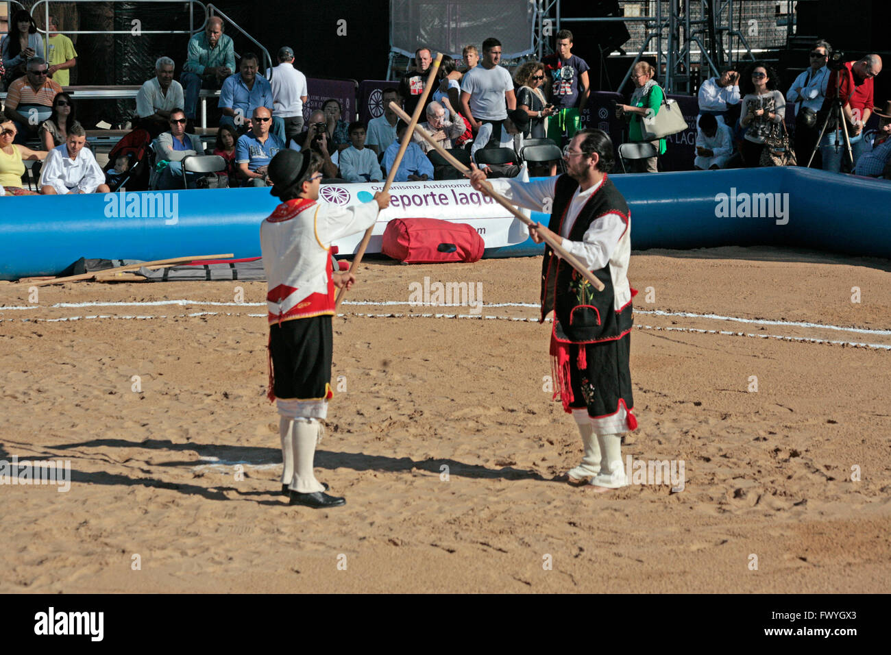 Teens playing the canarian stick wrestling in a public exhibition in ...